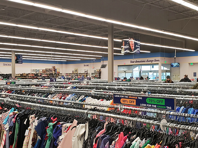 Rack after colorful rack stretches toward the horizon like a secondhand rainbow. The treasure hunt begins where the color-coded tags guide savvy shoppers to the best deals.
