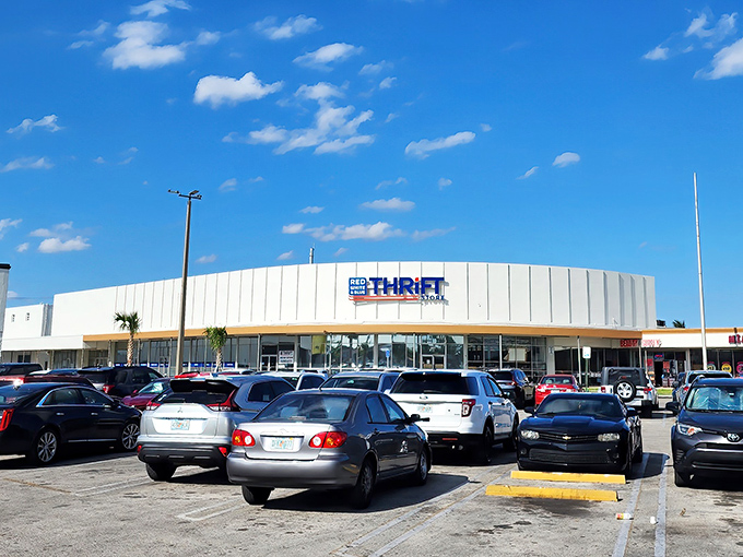 The curved white exterior of Red White & Blue Thrift Store stands like a retail colosseum where bargain gladiators come to conquer.