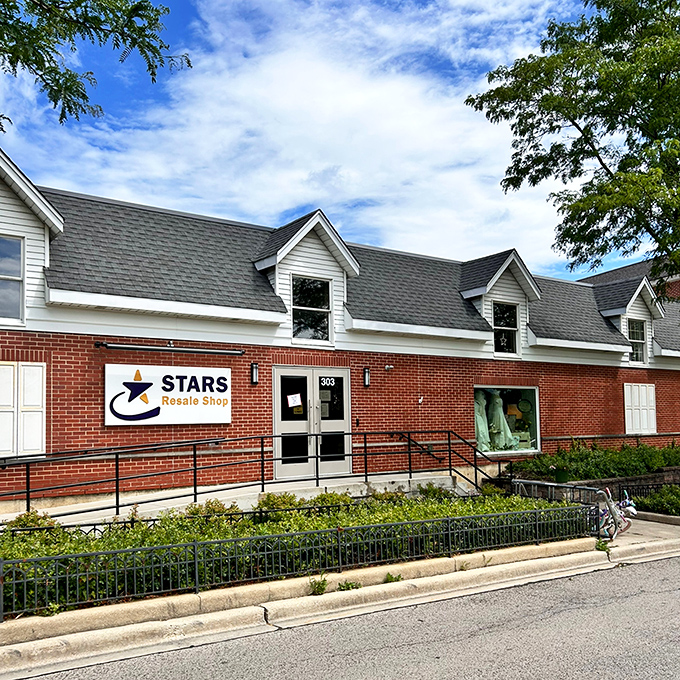 The charming brick facade of Stars Resale Shop stands ready to welcome bargain hunters under a perfect Illinois sky. Behind those doors, treasure awaits.