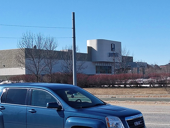 The iconic curved facade of South Portland's Goodwill stands like a treasure chest waiting to be opened, promising adventures in secondhand shopping.