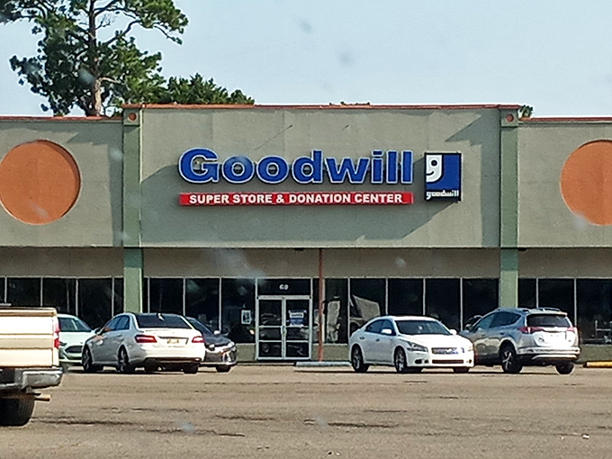 The blue Goodwill sign beckons like a lighthouse for bargain hunters, promising treasures waiting to be discovered inside.