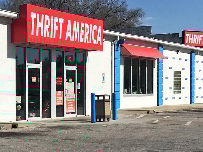 The bright red Thrift America sign stands out like a beacon for bargain hunters, promising treasures within those unassuming white walls.