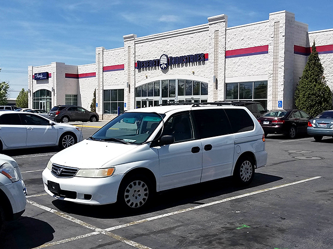 The white facade of Deseret Industries stands like a beacon of bargain hope against Utah's blue sky. Treasure hunters, your mothership has landed!