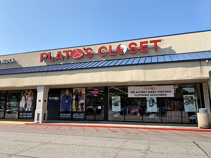 Sunlight gleams off the storefront where the "NOW BUYING" sign promises cash for your closet castoffs—one shopper's discard becomes another's treasure.