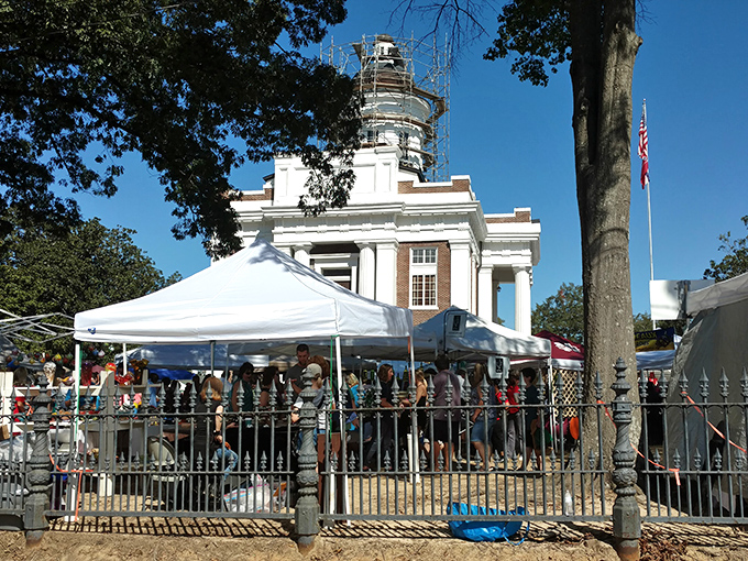 The historic Madison County Courthouse stands sentinel over white market tents as shoppers hunt for treasures in Canton's twice-yearly tradition.