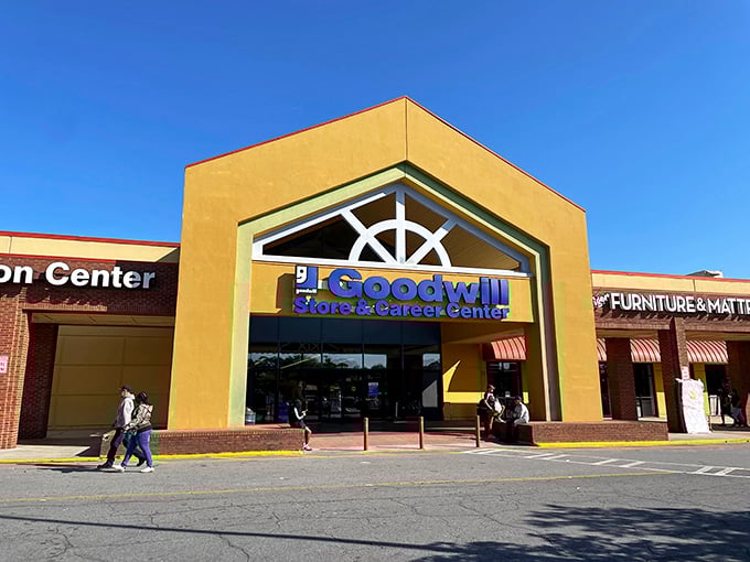 The yellow facade of Goodwill beckons like a treasure chest waiting to be opened, promising adventures in secondhand splendor on Atlanta's Buford Highway.