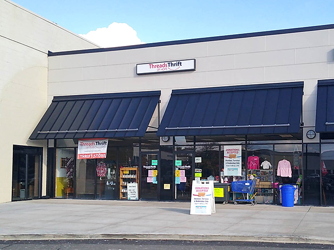 The unassuming storefront of Threads of Hope hides a treasure trove within, like finding a secret passage to bargain paradise.