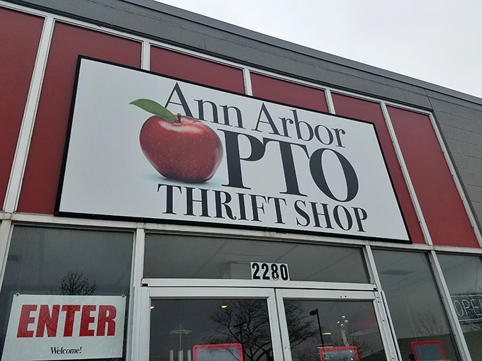 The iconic red-bordered sign of Ann Arbor PTO Thrift Shop beckons bargain hunters with its apple logo promise.
