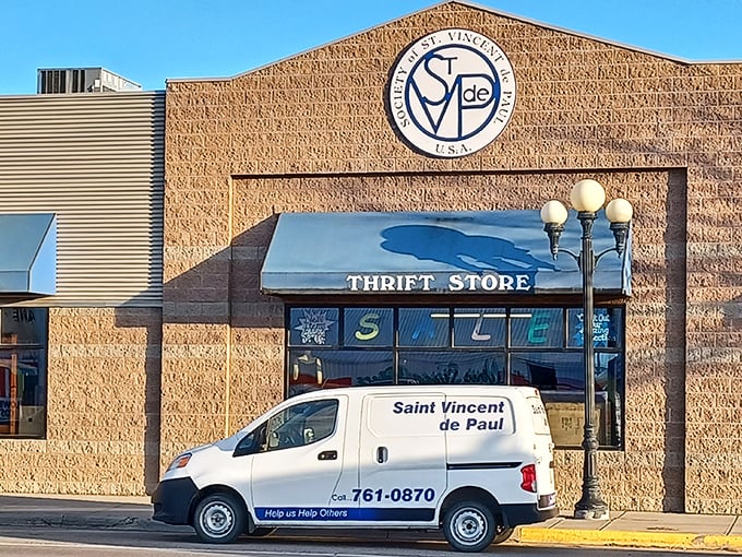 The brick fa&ccedil;ade of St. Vincent de Paul stands like a humble guardian of treasures, its logo promising adventures in secondhand splendor.