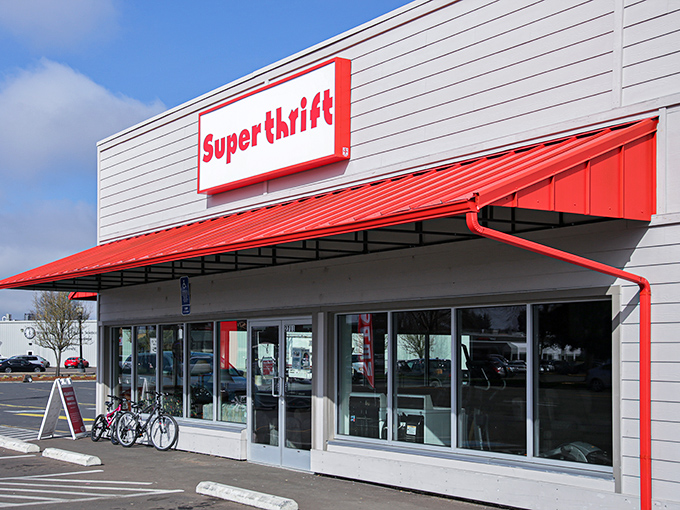 The bright red SuperThrift sign beckons bargain hunters like a retail lighthouse, promising treasures within those sliding glass doors.