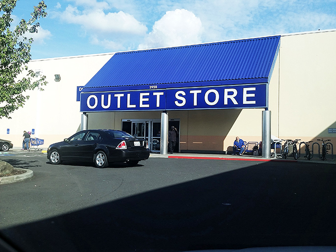Welcome to organized chaos! Shoppers navigate the sea of blue bins with the determination of gold rush prospectors seeking their fortune.