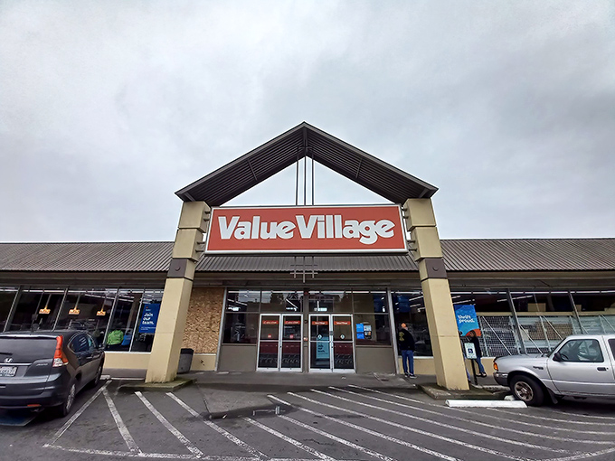 The iconic red sign beckons like a lighthouse for bargain hunters. Value Village's distinctive triangular entrance has become a symbol of thrifting adventure in Burien.