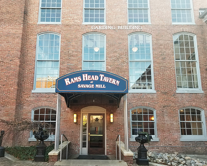 The historic brick facade of Savage Mill welcomes treasure hunters with its imposing presence and the promise of Ram's Head Tavern refreshments after a day of antiquing.