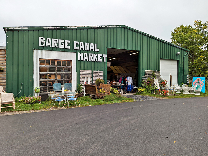 The green warehouse beckons like a vintage siren, with treasures spilling out the door and promising adventures in secondhand paradise.