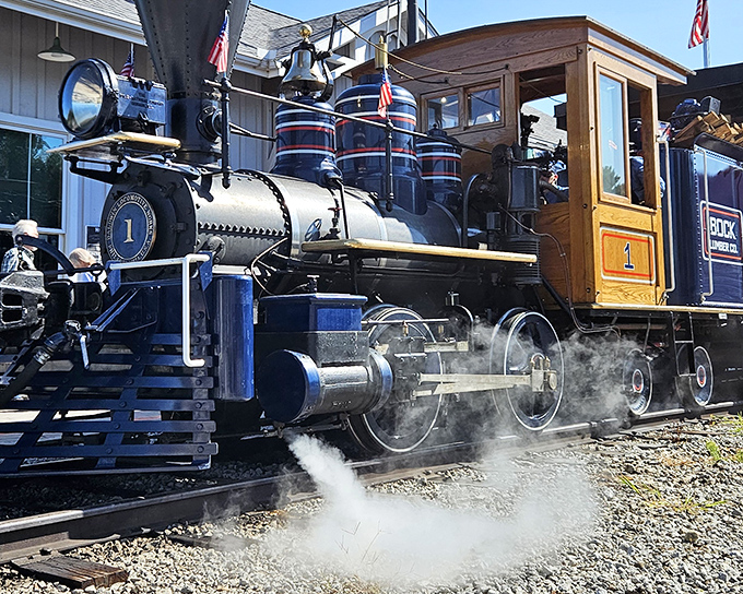 This magnificent steam locomotive stands like a sleeping giant, its massive drive wheels and gleaming black frame a testament to American engineering prowess that once thundered across the Midwest.