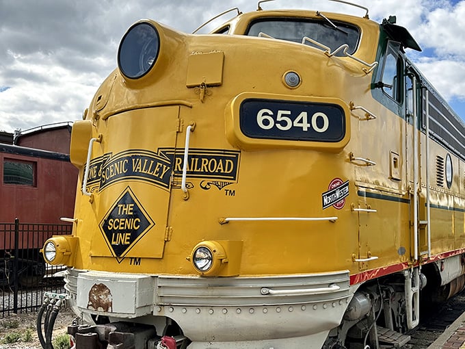 The gleaming yellow #6540 locomotive stands like a time machine on wheels, ready to transport you back to railroading's golden age.
