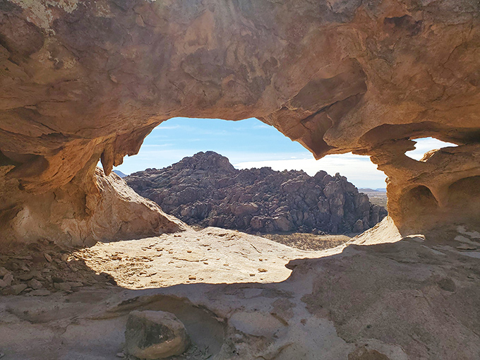 Nature's perfect window frame! This natural rock formation offers a breathtaking view that no Instagram filter could ever improve upon.