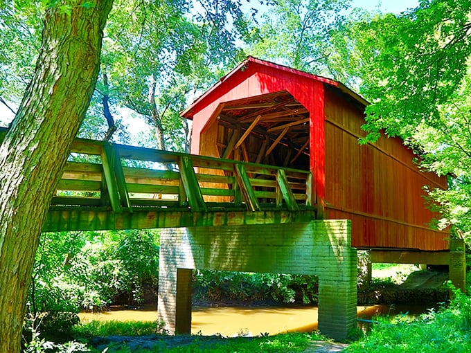 Nature frames this architectural time capsule perfectly, the vibrant red siding popping against summer greenery like Illinois' answer to a New England postcard.