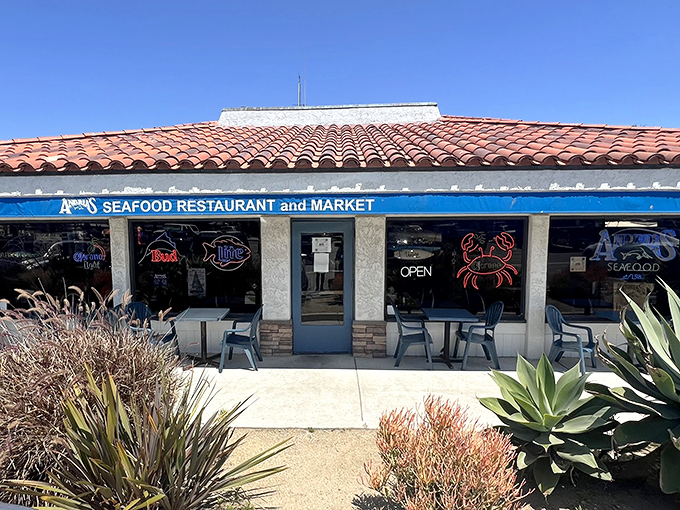 Andria's welcoming exterior beckons seafood lovers with its classic coastal charm. The terra cotta roof and blue trim promise maritime delights within.