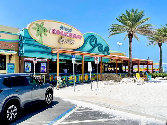 The iconic wave-inspired facade of Frenchy's Rockaway Grill welcomes beach-goers with its vibrant colors and promise of seafood paradise.