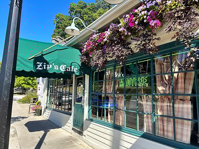 The charming facade of Zip's Cafe welcomes you with vibrant flower boxes and that iconic green awning—like a neighborhood friend waving you in for dinner.
