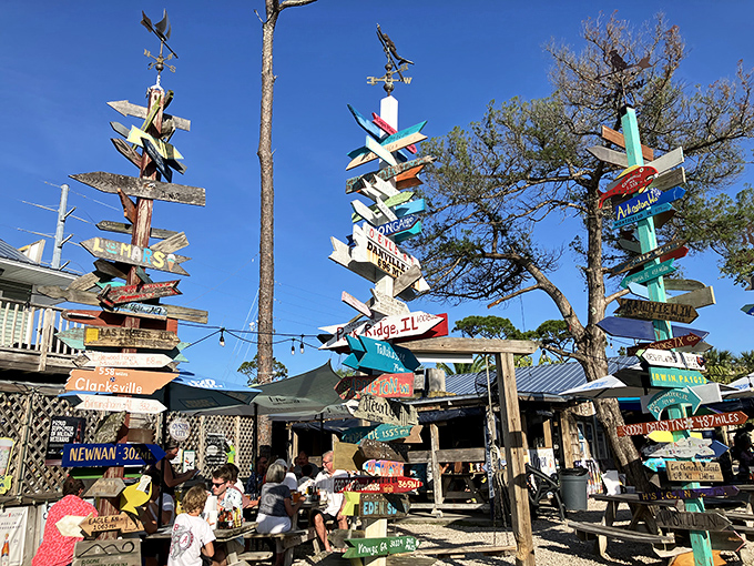 Gathering around the colorful signs and good company! This unique outdoor spot is perfect for food and fun. Island time!