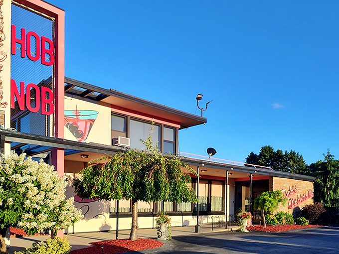 The iconic red HOBNOB sign beckons like a lighthouse for the hungry, promising classic supper club delights within those mid-century walls.