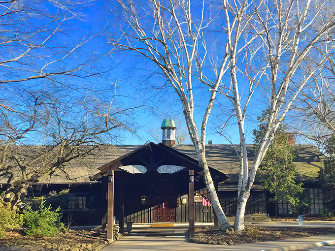 The Wooden Angel's distinctive entrance, with its namesake cutout above the doorway, stands like a culinary cathedral among graceful birch trees. A first glimpse that promises memorable meals await.