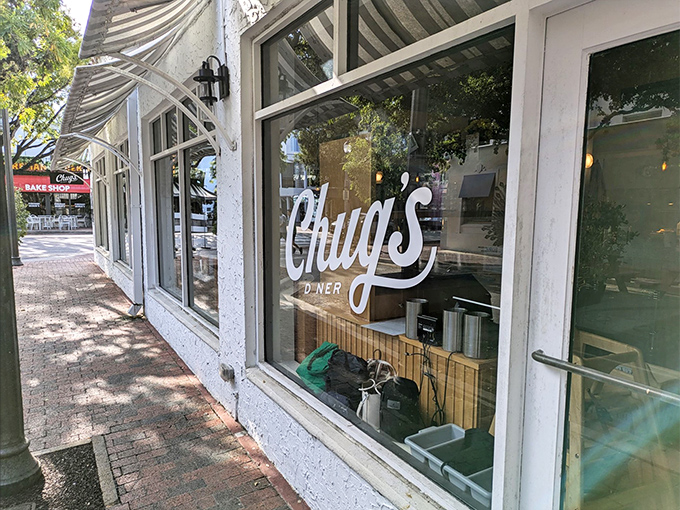 The unassuming storefront that houses culinary greatness. Chug's elegant script on glass promises Miami magic within those white walls.