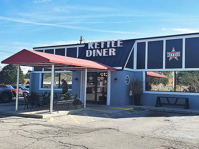 The unassuming exterior of The Kettle Diner, where culinary magic happens behind that red awning. Food paradise doesn't always wear fancy clothes.