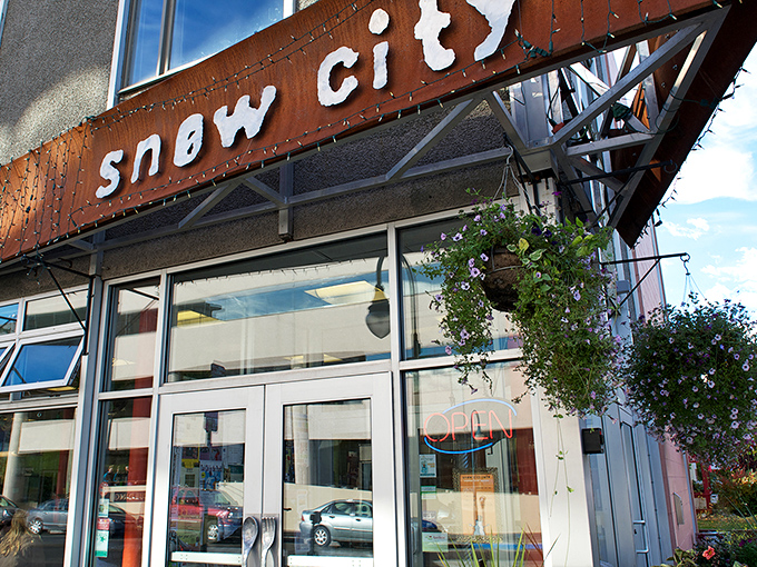 The iconic rust-colored sign welcomes hungry patrons like a beacon of breakfast hope in downtown Anchorage. Morning salvation awaits!