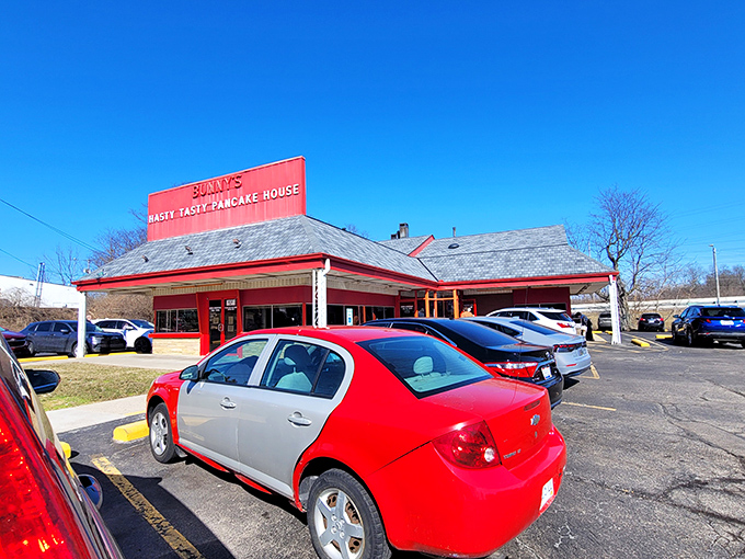 The bright red exterior of Bunny's Hasty Tasty Pancake House stands out like a beacon for breakfast lovers, promising comfort food and nostalgia under the Ohio sky.