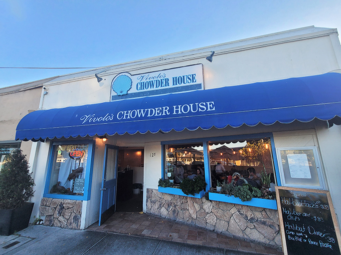 The iconic blue awning of Vivolo's stands like a maritime beacon, promising seafood treasures to those wise enough to venture inside.