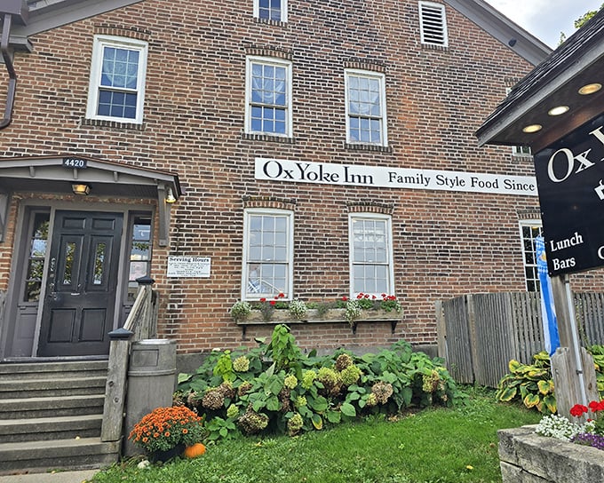The iconic brick exterior of Ox Yoke Inn welcomes hungry travelers with colorful flower beds and a promise of German-American comfort that's stood the test of time.