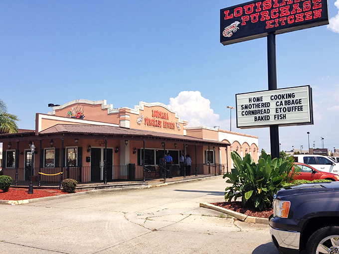 The peach-colored facade of Louisiana Purchase Kitchen stands like a culinary lighthouse, beckoning hungry travelers with promises of authentic Creole goodness.