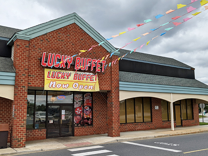 The bright red signage of Lucky Buffet stands out against the brick facade, like a culinary lighthouse beckoning hungry travelers to safe harbor.