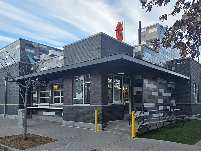 The modern brick exterior of Four Friends Kitchen stands like a culinary beacon in Denver's Stapleton neighborhood, promising comfort food with Colorado flair.