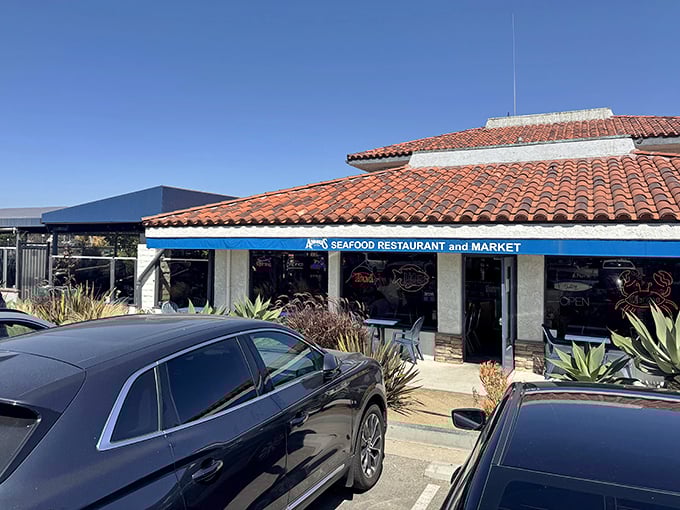 Andria's welcoming exterior beckons seafood lovers with its classic coastal charm. The terra cotta roof and blue trim promise maritime delights within.