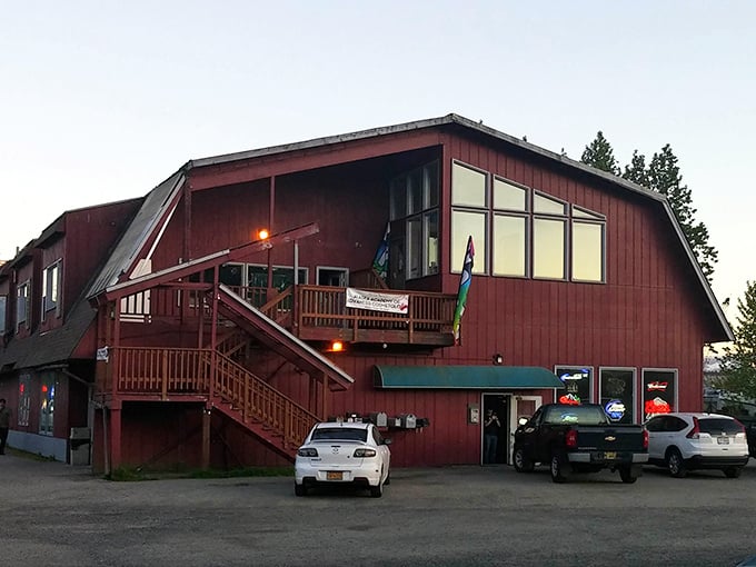 The weathered red exterior of Sandbar & Grill stands like a culinary lighthouse for locals, promising seafood treasures within those humble walls.