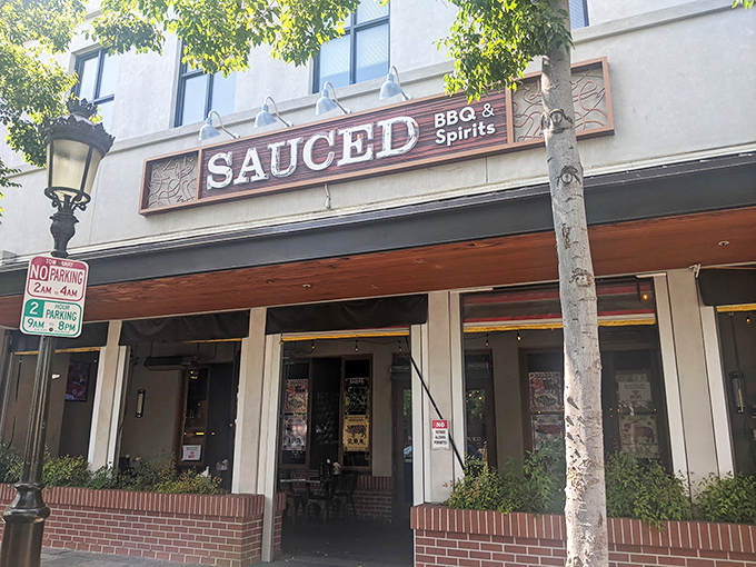 The welcoming storefront of Sauced BBQ & Spirits stands ready to lure in hungry Livermore locals with promises of smoky delights and spirited libations.