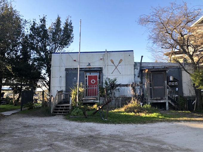 With its weathered white siding and bright red door, The Wreck looks like the kind of place where fishermen might swap tales while their catch becomes tomorrow's special.