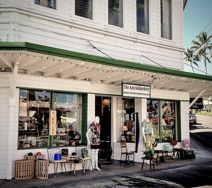 The corner building with its classic white facade and green trim stands like a time portal in downtown Hilo, beckoning curious souls to step inside and explore.