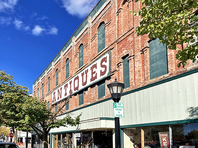 The brick facade of Bay Antique Center stands like a temple to treasures past, its vintage "ANTIQUES" sign a siren call to collectors and the curious alike.