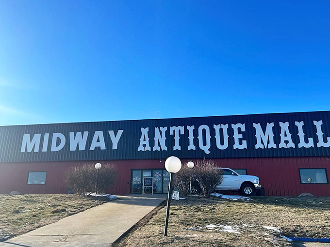 The iconic red exterior of Midway Antique Mall stands out against Missouri's blue sky like a beacon for treasure hunters everywhere.