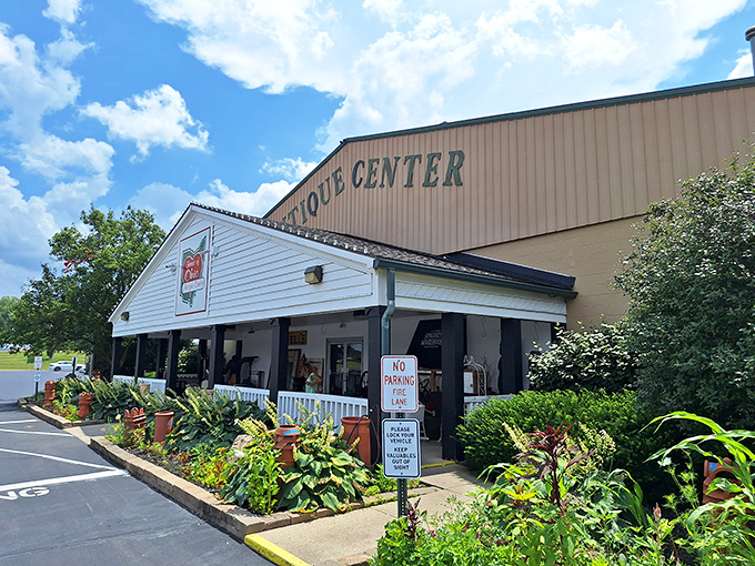 The welcoming facade of Heart of Ohio Antique Center stands like a time portal disguised as a charming country store. Those hanging plants aren't just decoration&mdash;they're sentinels guarding treasure within.