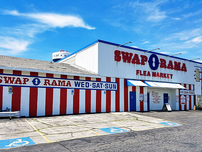 The red and white striped exterior of Swap-O-Rama stands like a circus tent for commerce, promising treasures inside for the bargain-savvy explorer.