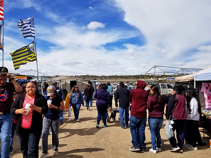 The bustling pathways of Gallup Flea Market, where treasure hunters navigate a sea of canopies under New Mexico's impossibly blue skies.