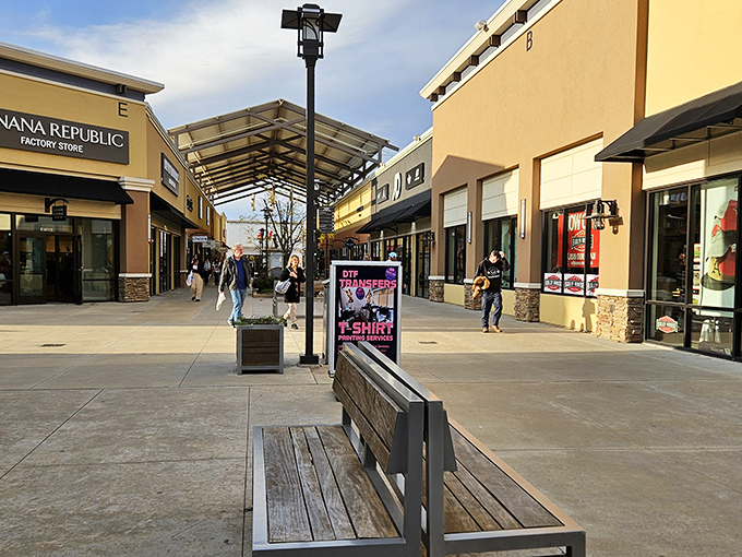 The open-air design of Outlets of Little Rock creates a shopping oasis where bargain hunters stroll between stores under Arkansas skies, pausing occasionally at wooden benches for retail strategy sessions.