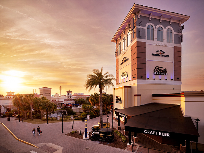 As the sun sets on another shopping day, the outlet's iconic tower glows with promise &ndash; tomorrow brings new treasures and deeper discounts.