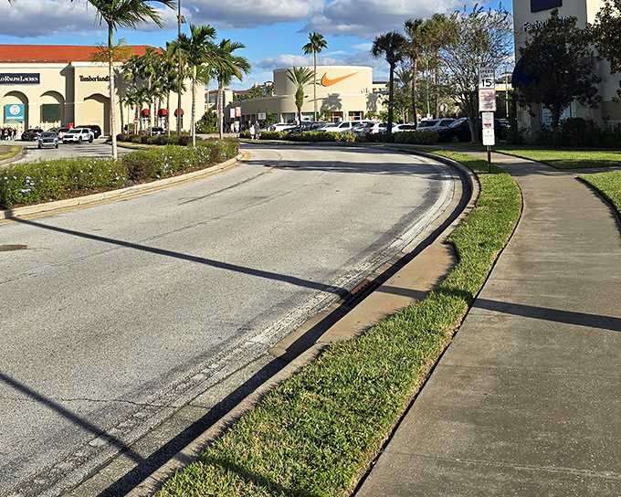 The Mediterranean-inspired entrance to Orlando Vineland Premium Outlets welcomes shoppers with palm trees and promise—retail therapy's most scenic starting line.